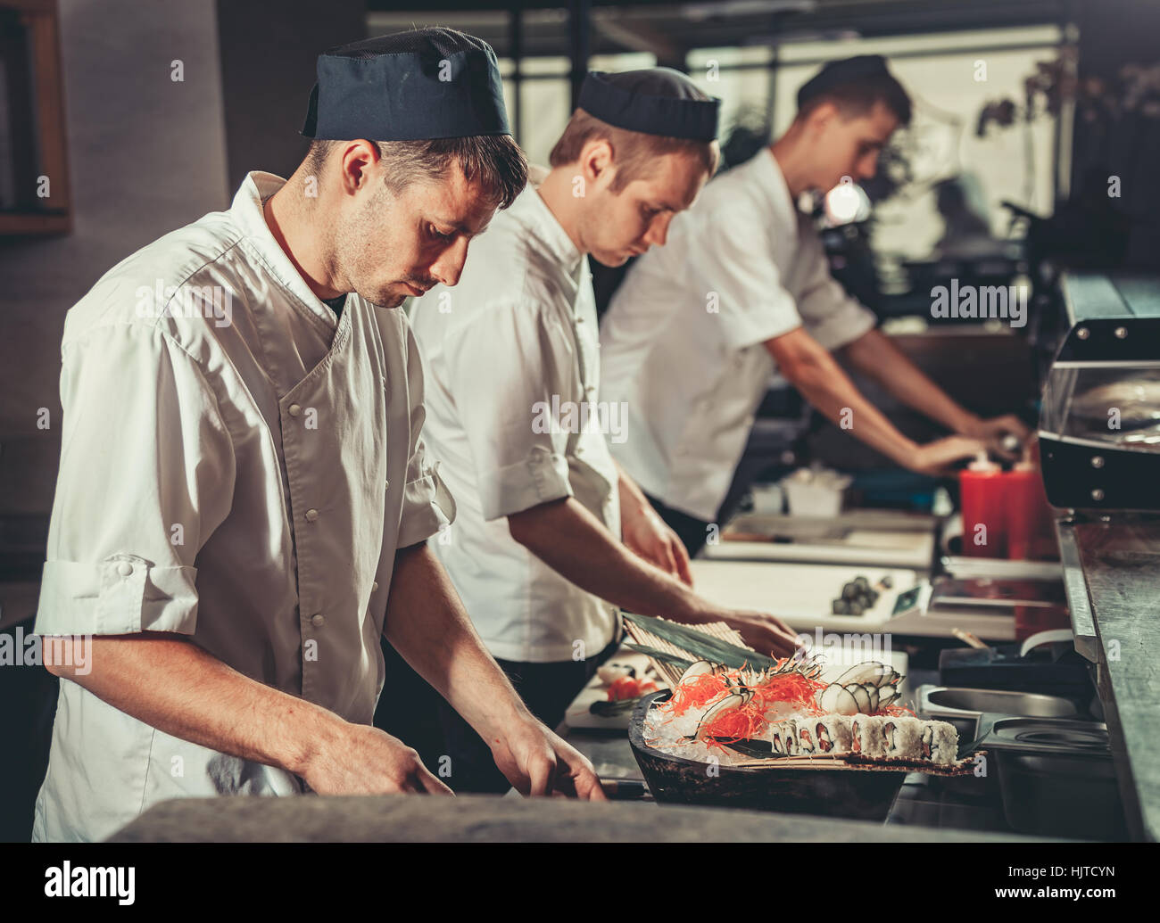 Busy chefs at work in the restaurant kitchen Stock Photo - Alamy
