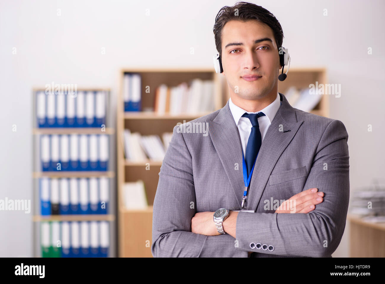 Handsome customer service clerk with headset Stock Photo - Alamy