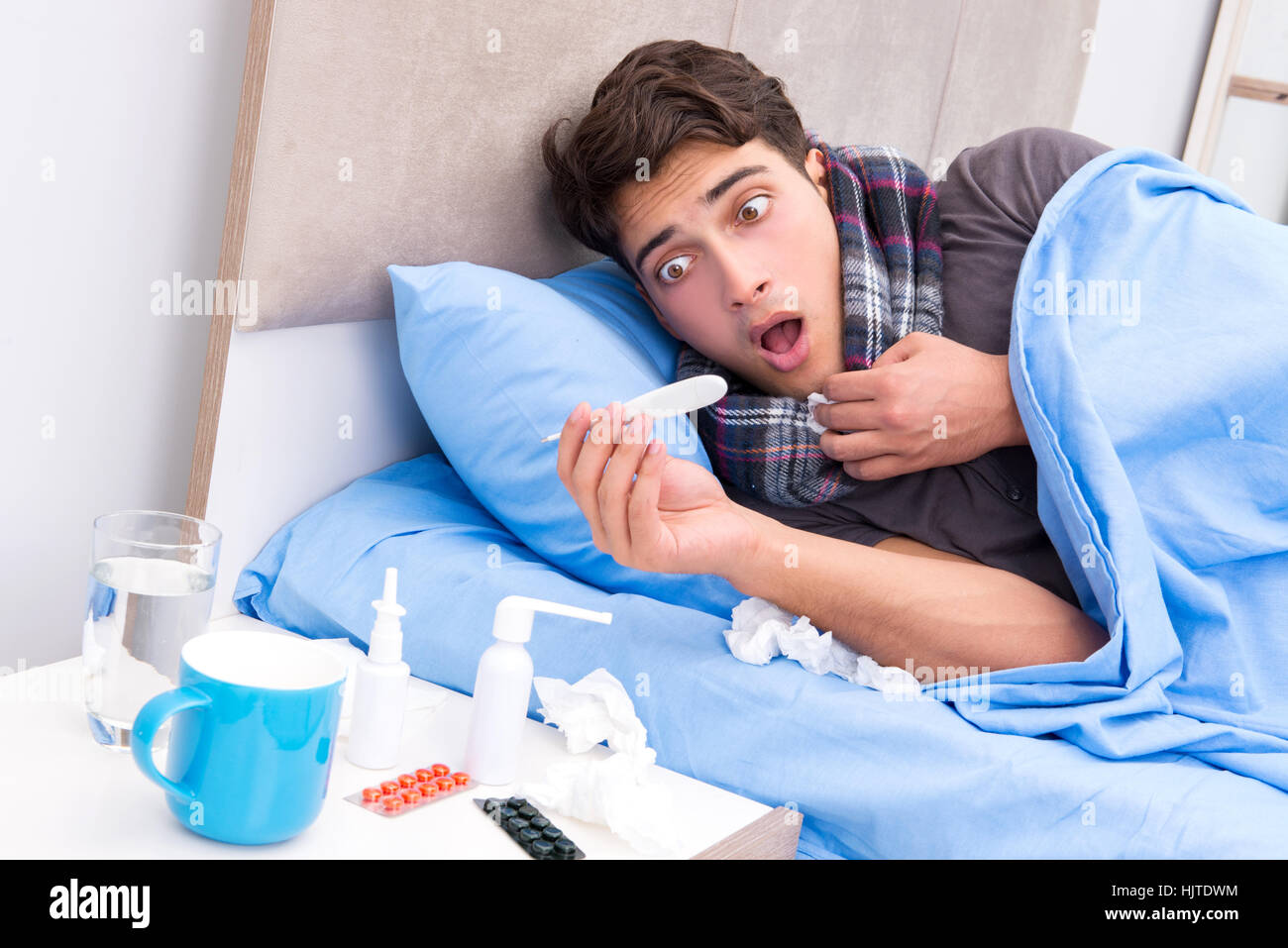 Sick man with flu lying in the bed Stock Photo - Alamy