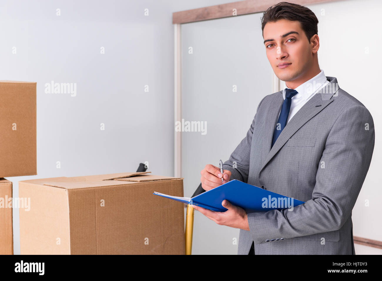 Man signing for the delivery of boxes Stock Photo - Alamy