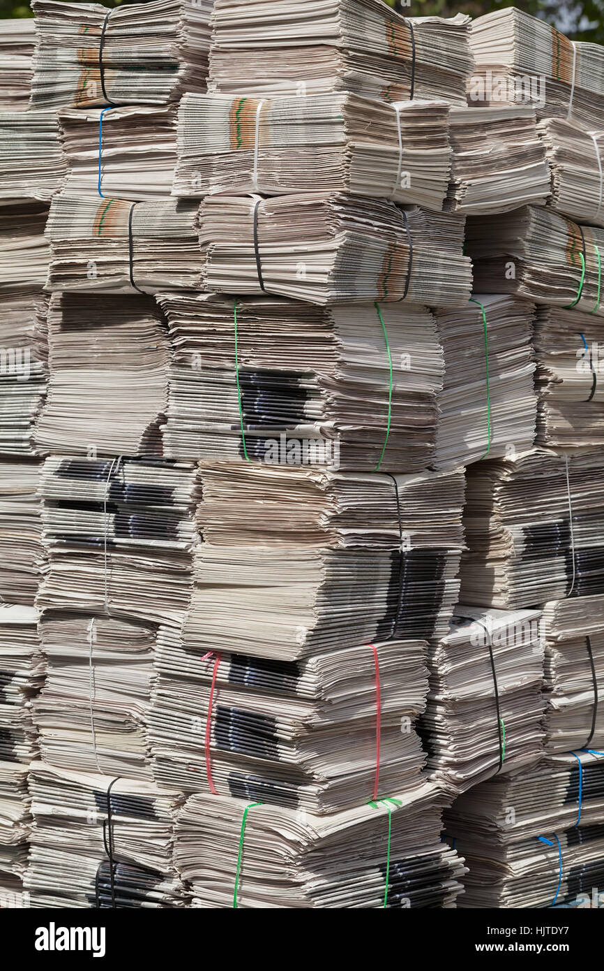 pile of newspapers for recycling in packages , note shallow depth of ...