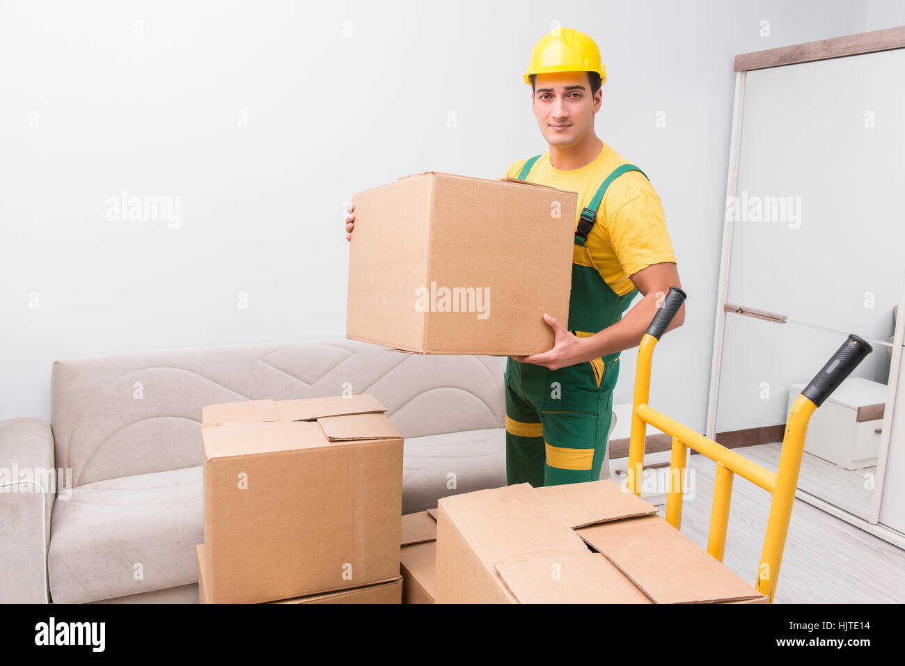 Transportation worker delivering boxes to house Stock Photo - Alamy