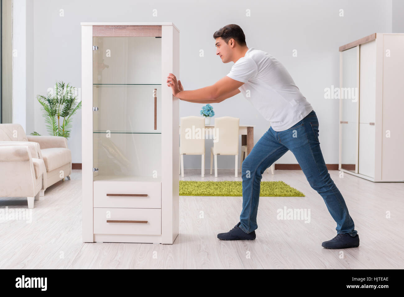Man moving furniture at home Stock Photo - Alamy