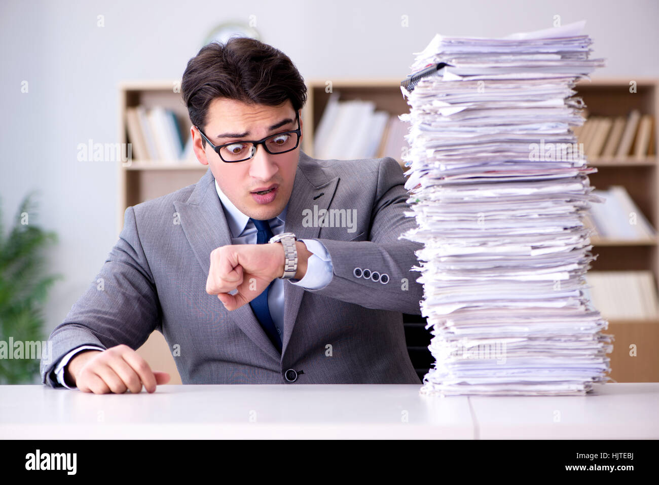Businessman struggling to meet challenging deadlines Stock Photo - Alamy