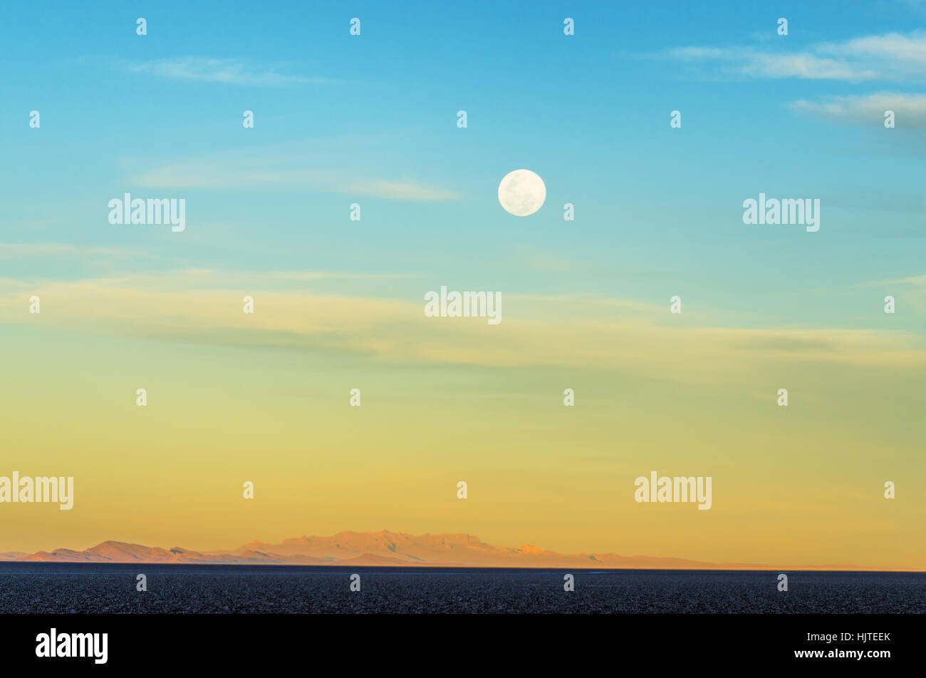 Moon brightly visible over the salt flats of Uyuni, Bolivia Stock Photo ...