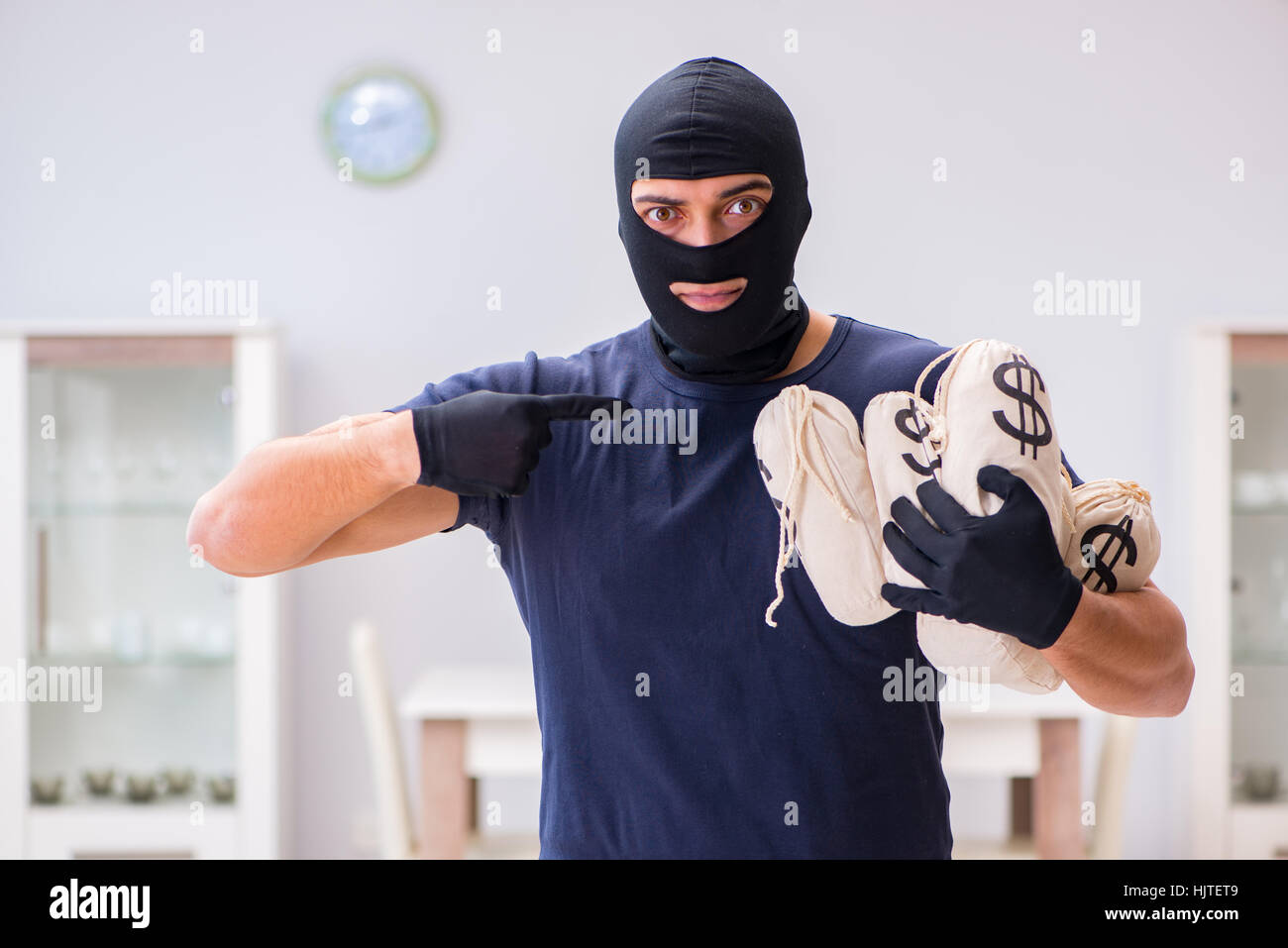 Robber wearing balaclava stealing valuable things Stock Photo - Alamy