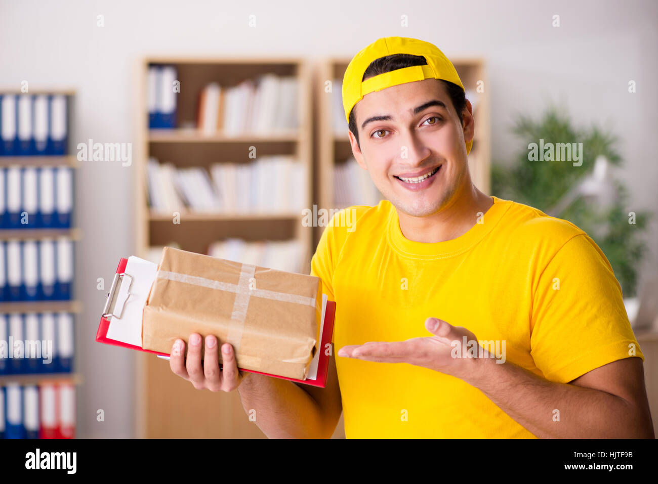 Delivery man delivering parcel box Stock Photo - Alamy