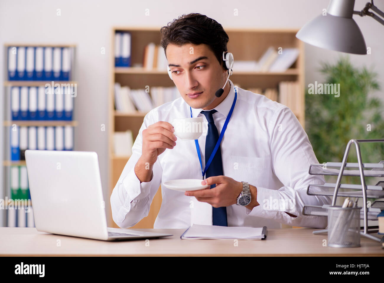Handsome customer service clerk with headset Stock Photo - Alamy