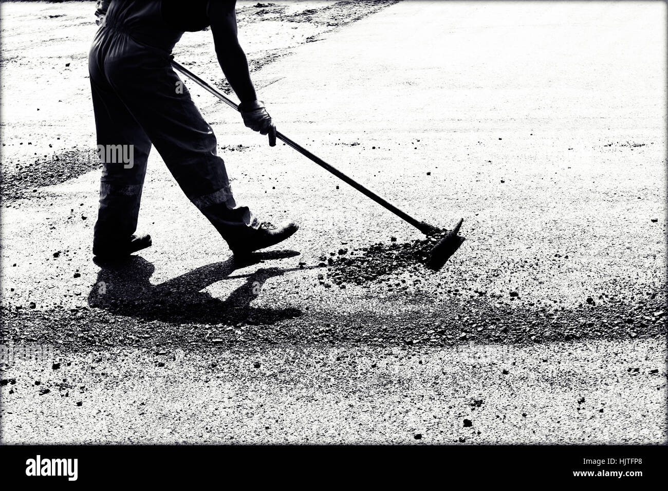 Worker on asphalting the road Stock Photo - Alamy