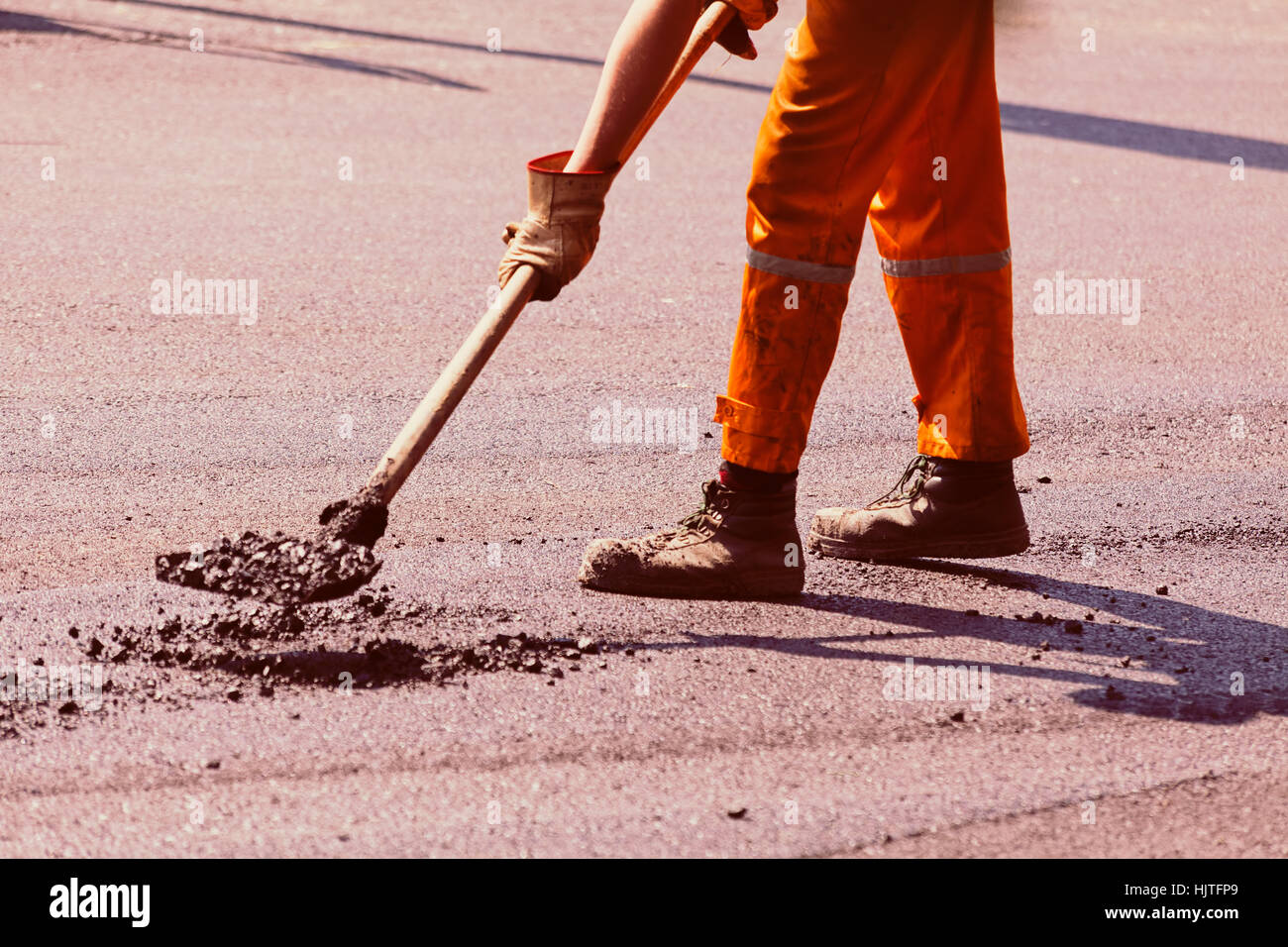 Worker on asphalting the road Stock Photo - Alamy