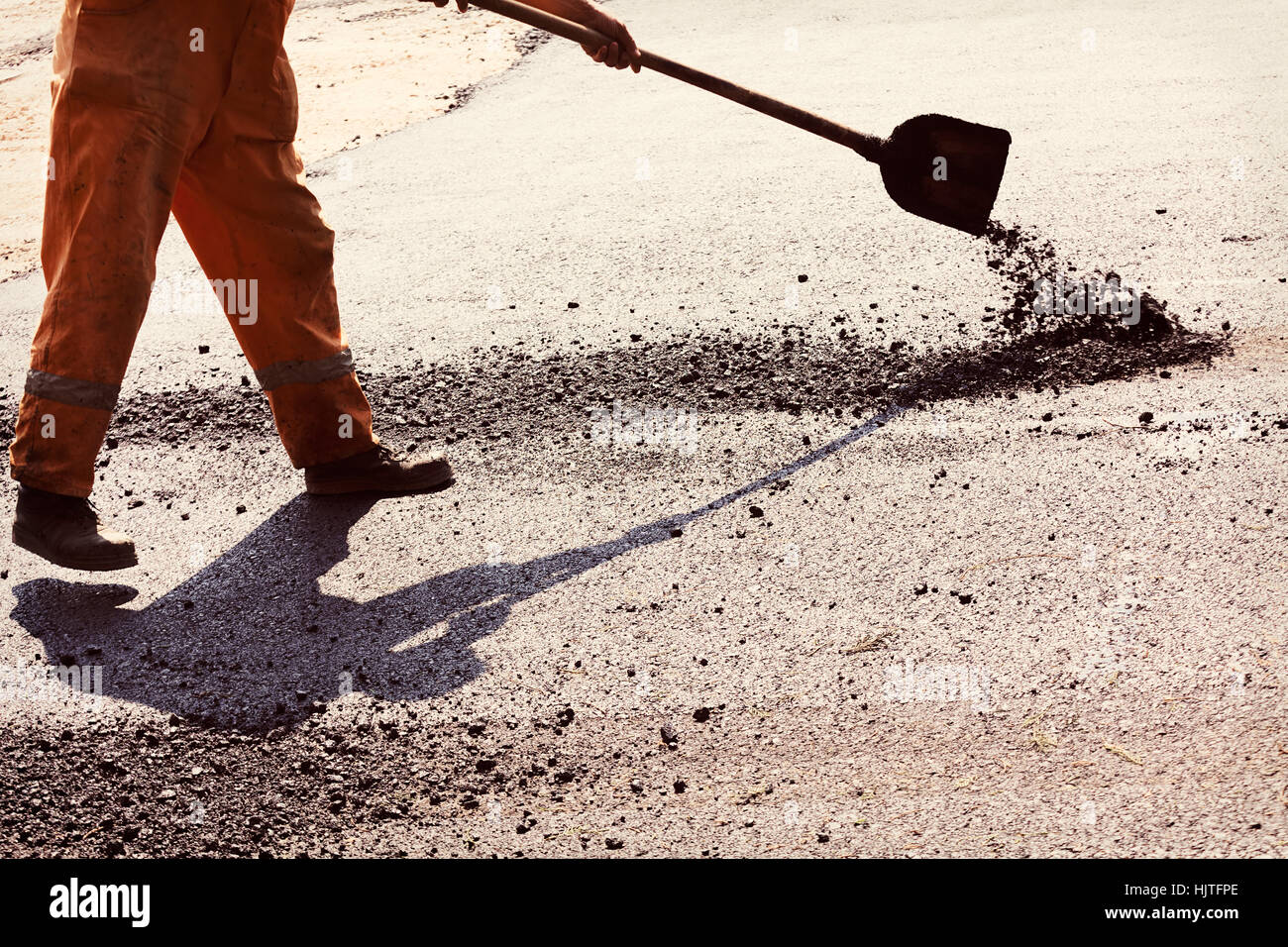 Worker on asphalting the road Stock Photo - Alamy
