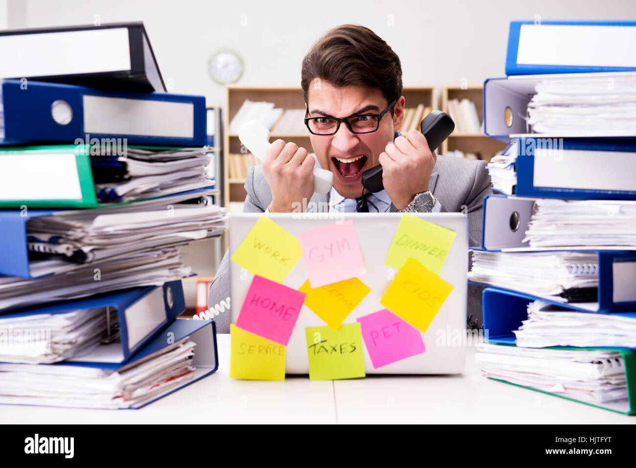 Businessman struggling with multiple priorities Stock Photo - Alamy