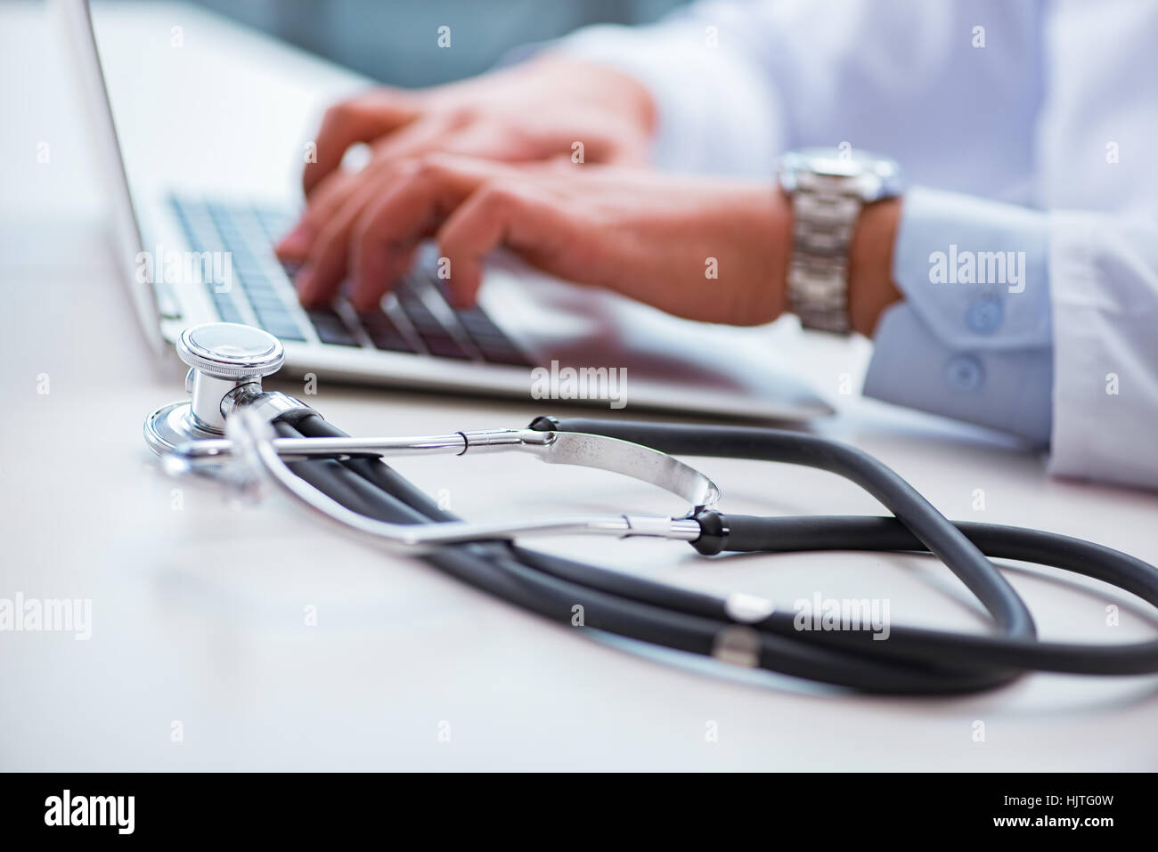 Doctor working on the computer Stock Photo - Alamy