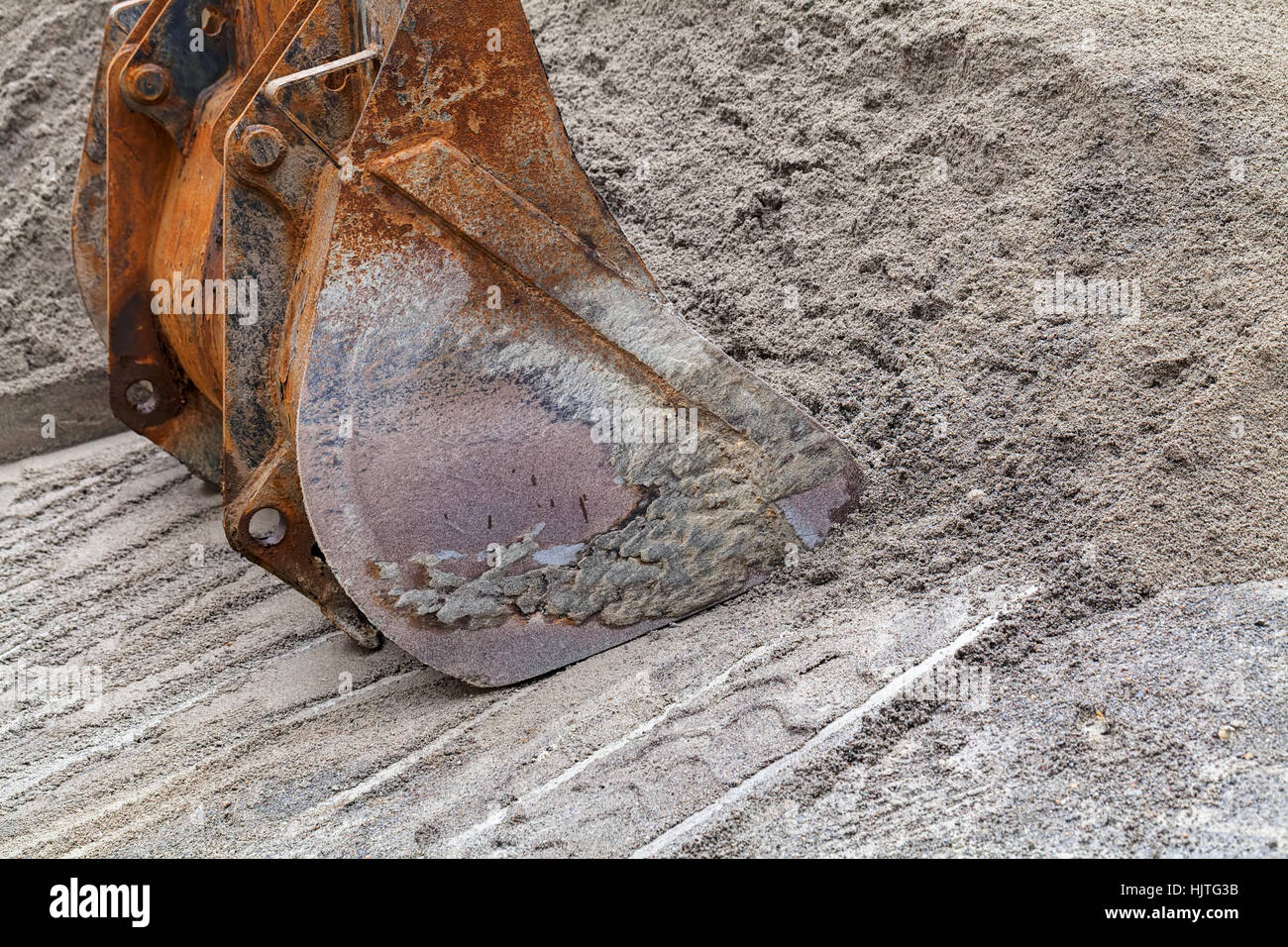 loading sand with bucket on the excavator, note shallow depth of field ...