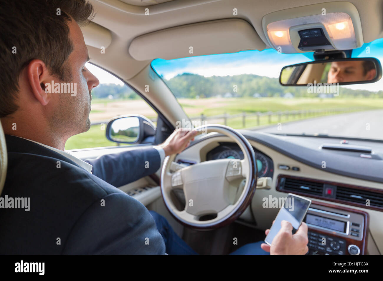 Man using cell phone while driving Stock Photo - Alamy