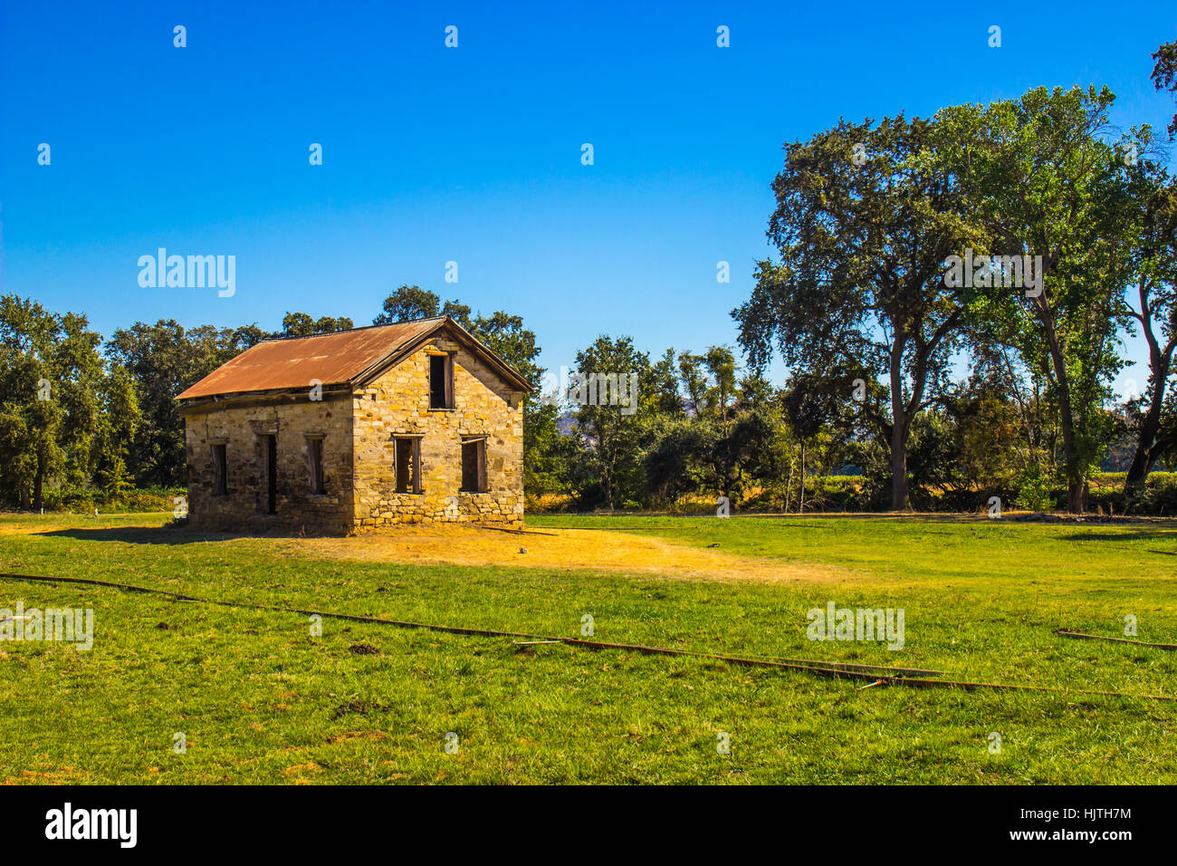 Vintage Stone Building Situated In Open Field Stock Photo - Alamy