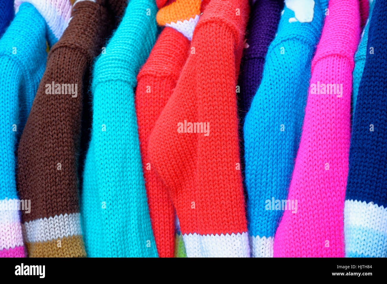 colorful wool sweaters hung vertically and profile Stock Photo - Alamy
