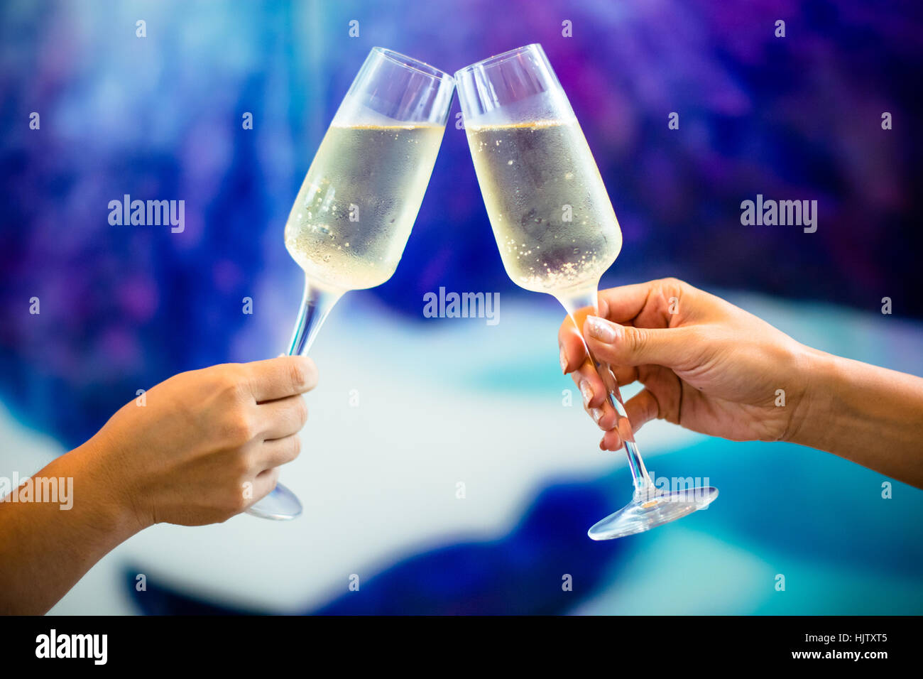 Bubbly Champagne Toast in Front of Blue and Purple Background Stock ...