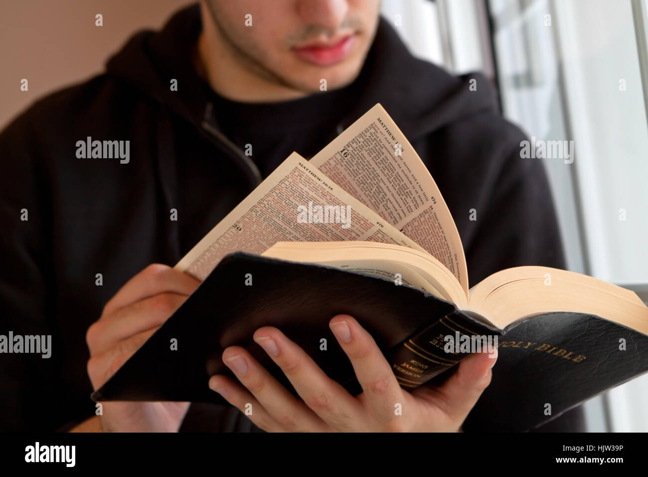 Man holding bible hi-res stock photography and images - Alamy