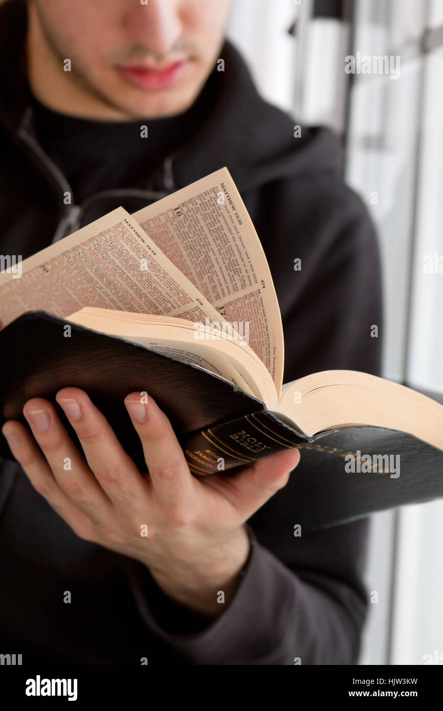 Man reading holy bible hi-res stock photography and images - Alamy