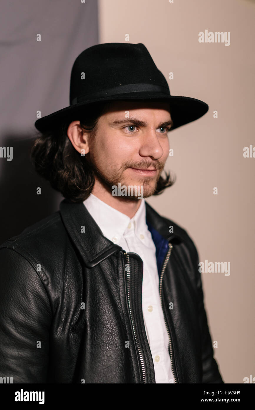 guy in a hat and leather jacket Stock Photo - Alamy