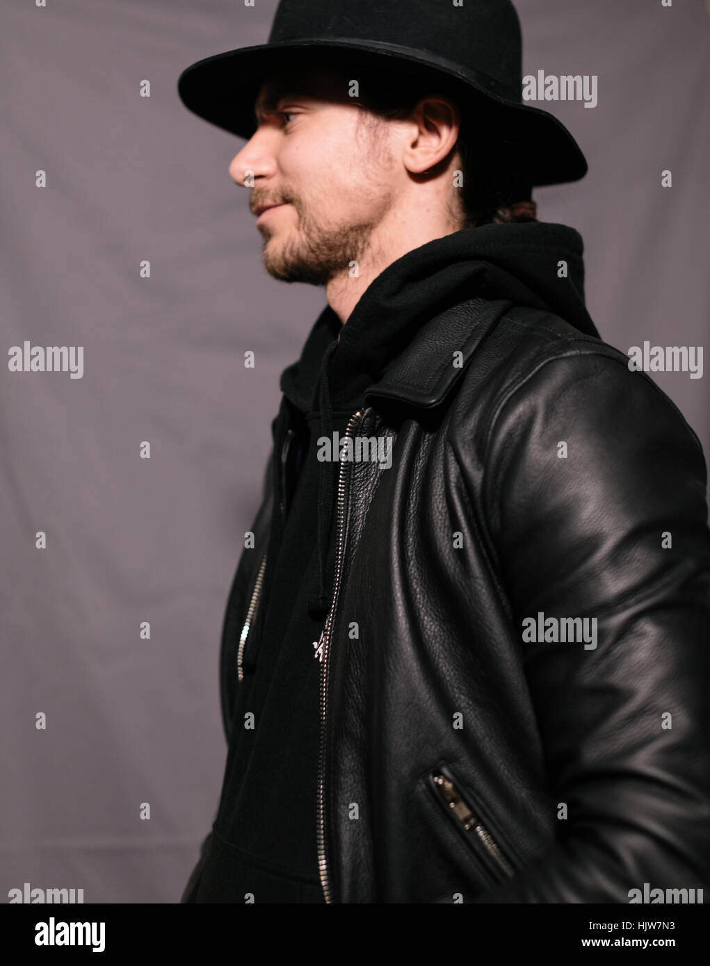guy in a hat and leather jacket Stock Photo - Alamy