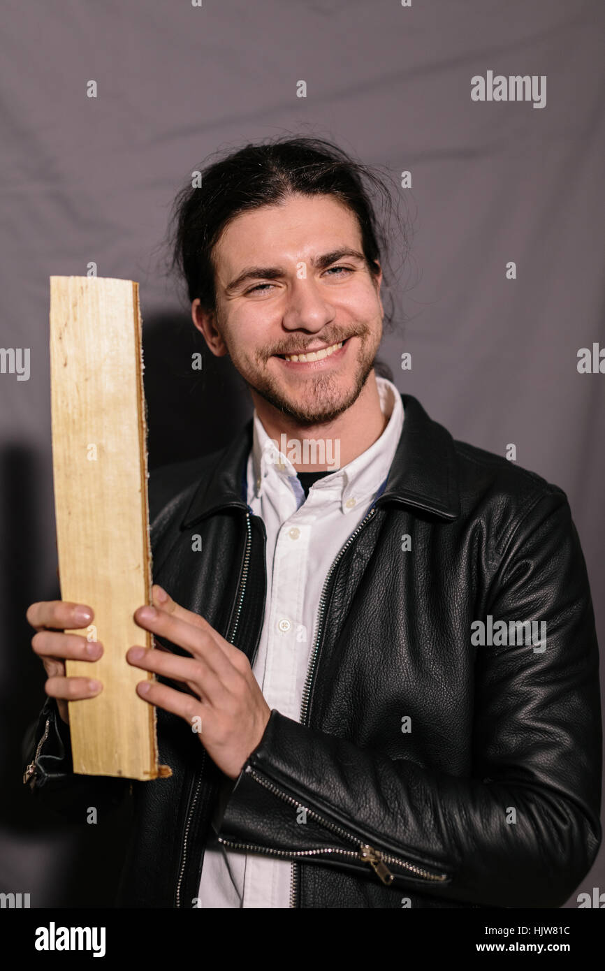 Man in the hands of birch logs Stock Photo - Alamy