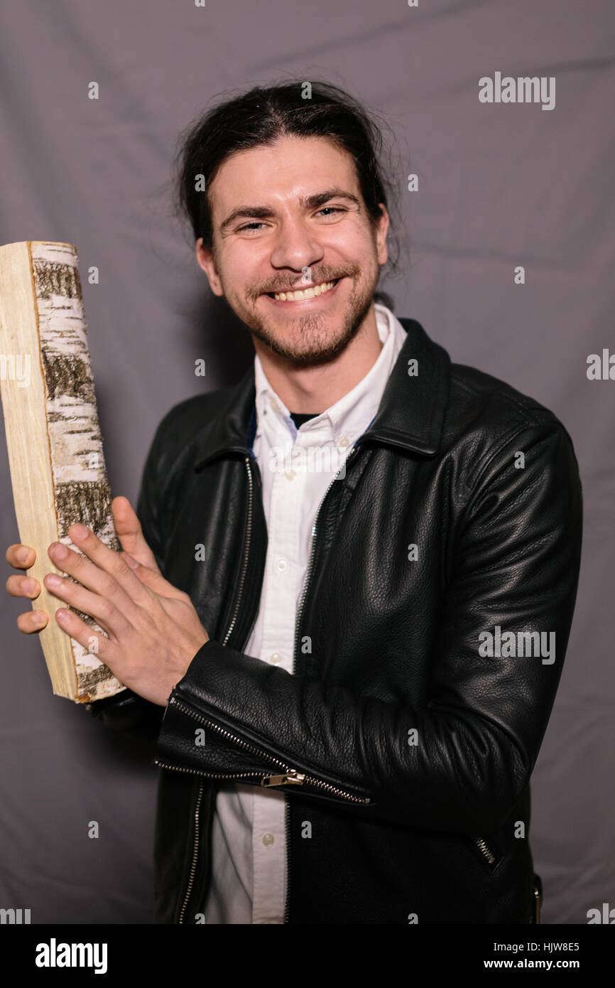 Man in the hands of birch logs Stock Photo - Alamy