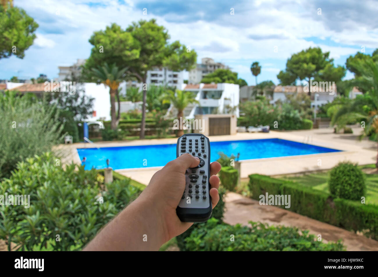 Summer vacation concept. Man holding remote control Stock Photo - Alamy