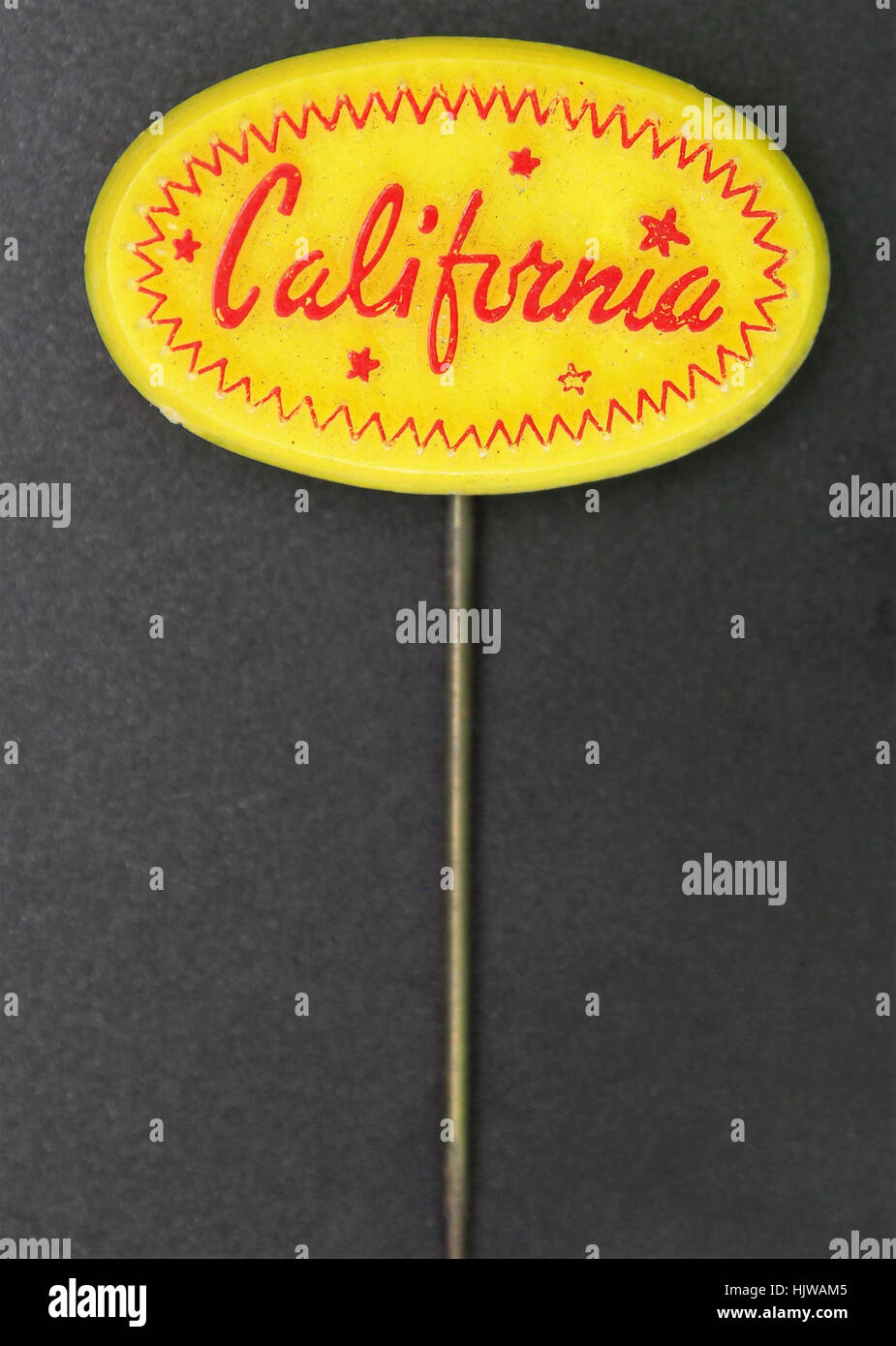 A vintage yellow advertising pin from California, potentially ...