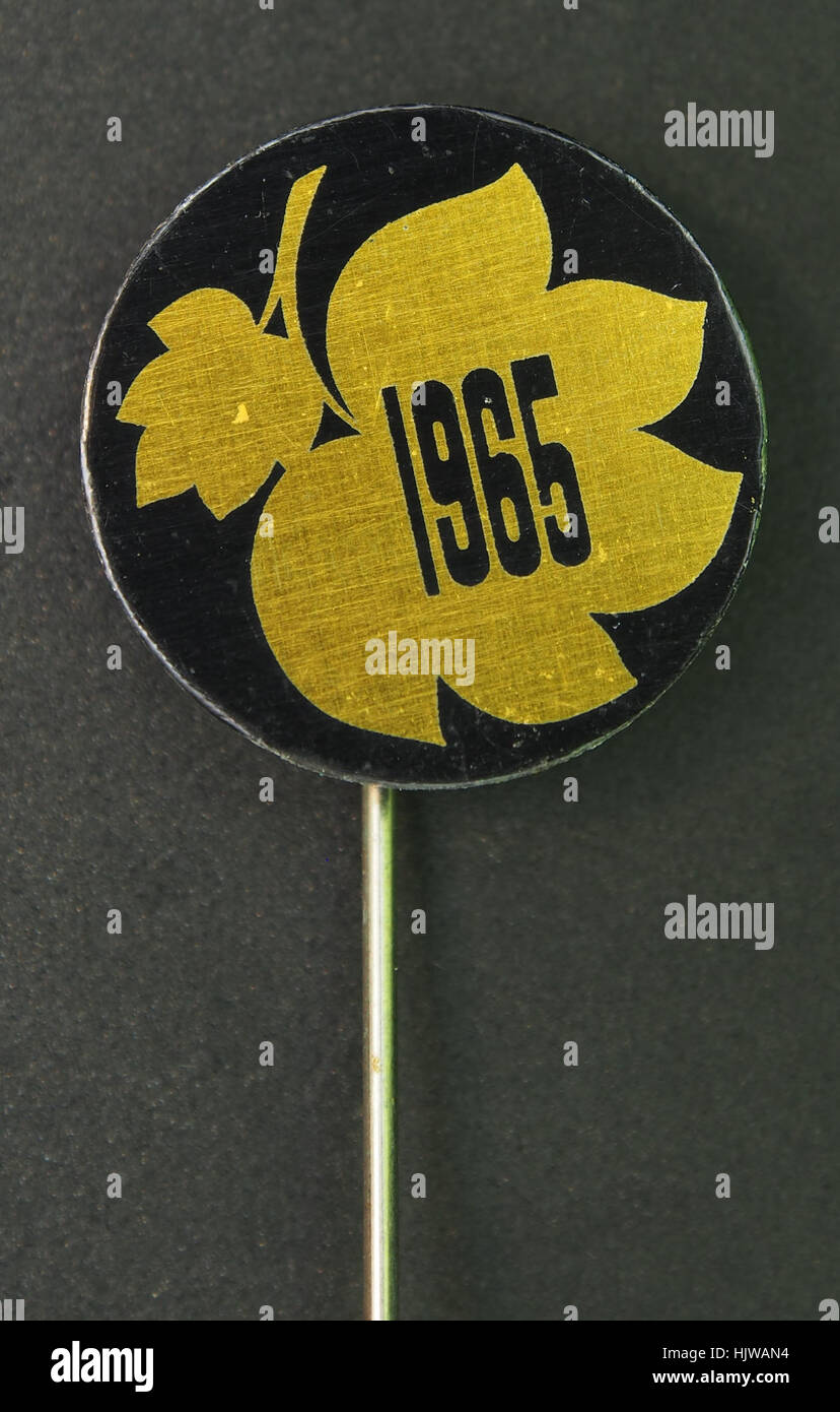 A vintage 1965 advertising pin, likely commemorating a product or event ...