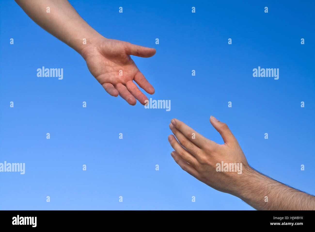 Hands reaching towards each other Stock Photo - Alamy