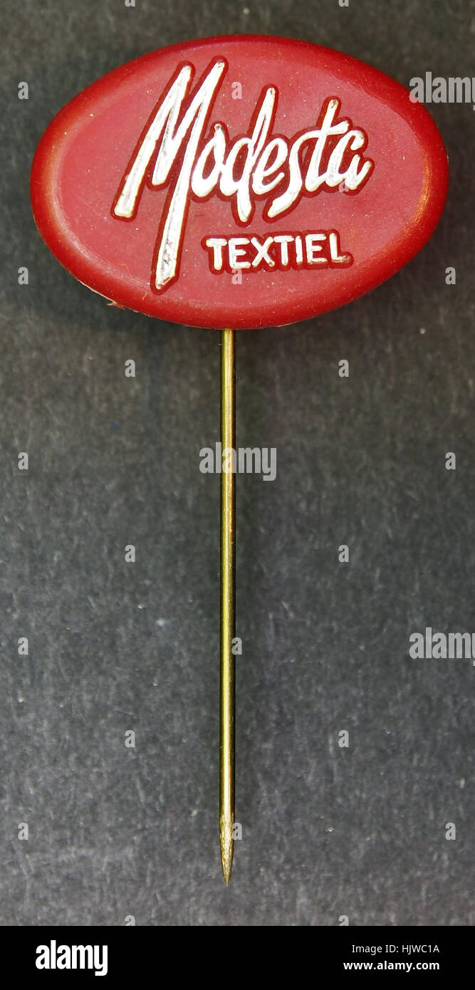 Modesta Textiel speltje, an advertising pin for Modesta Textiel, a well ...