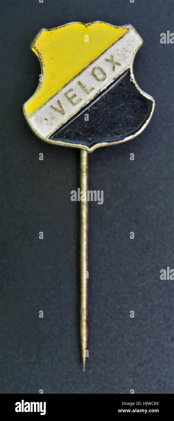 A vintage advertising pin for Velox, a brand known for its paper and ...