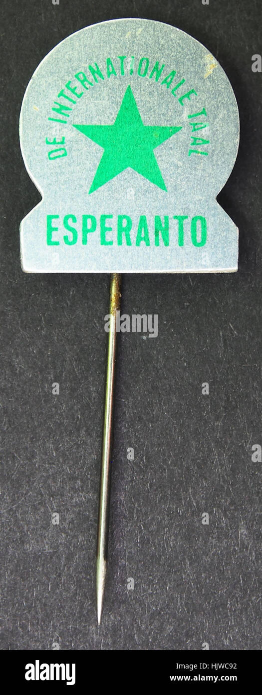 This advertising pin features the symbol of Esperanto, the ...