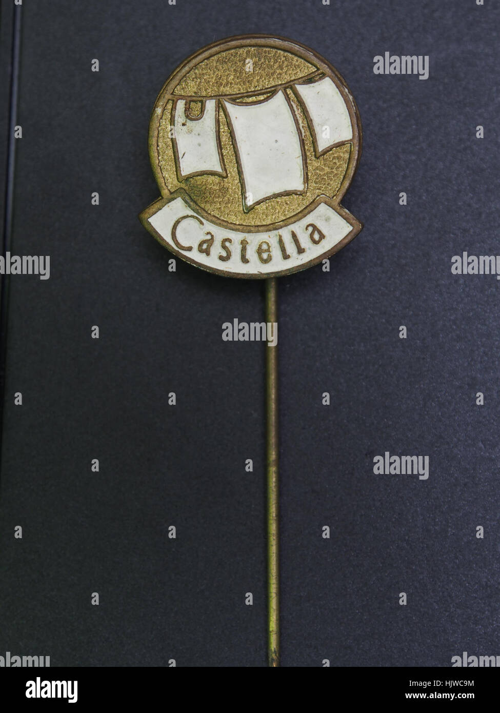 A vintage pin advertising Castella, featuring a washing line design ...