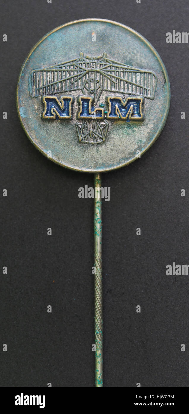 A vintage advertising pin for NLM (Netherlands Leased Motor), promoting ...