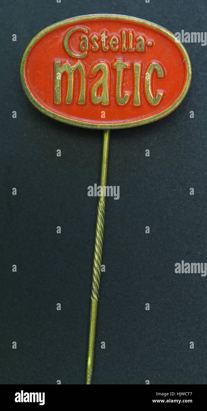 The Castella Matic advertising pin, in orange, represents a brand known ...