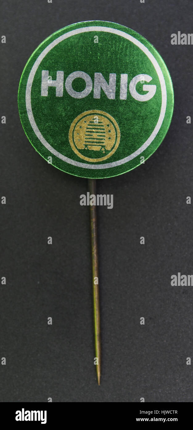 The Honig advertising pin, a vintage promotional item, represents the ...
