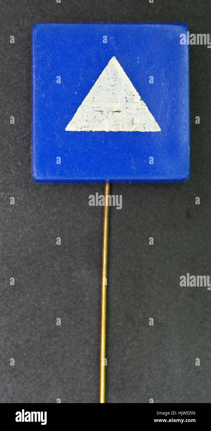 A traffic sign advertising pin, a collectible item promoting road ...