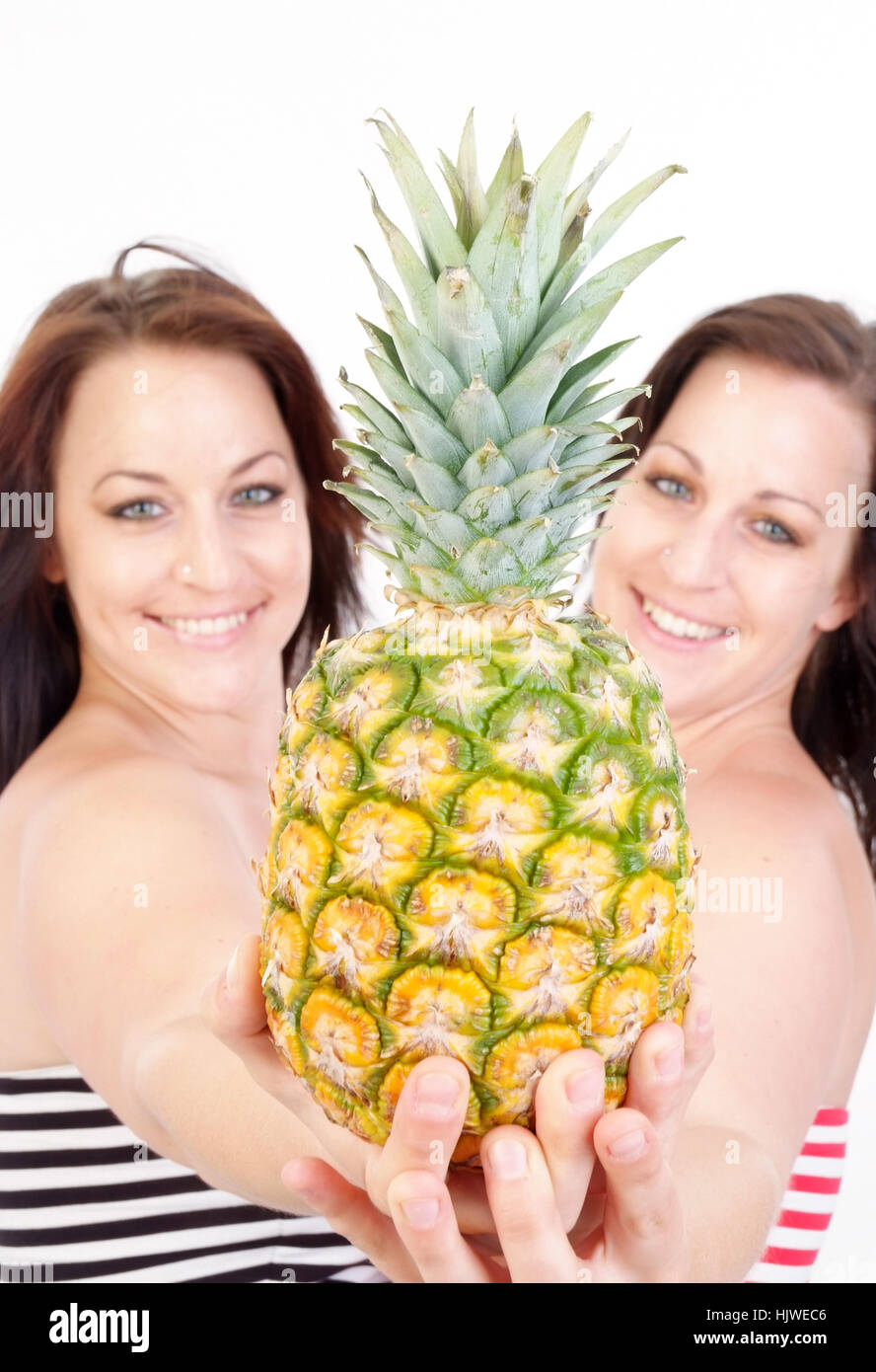 Twins with pineapple Stock Photo - Alamy