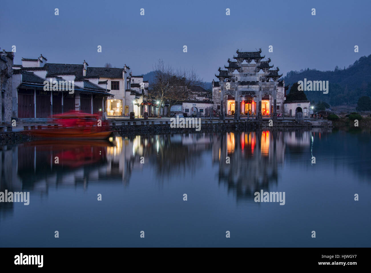 Paifang gate at night in the UNESCO World Heritage ancient village of ...