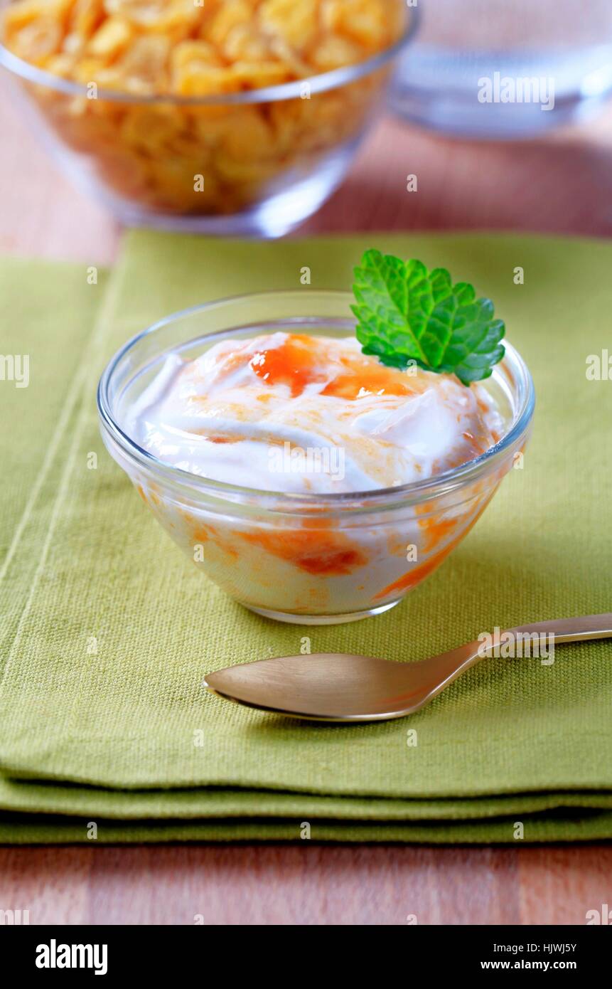 Bowl of yogurt, corn flakes in the background Stock Photo - Alamy