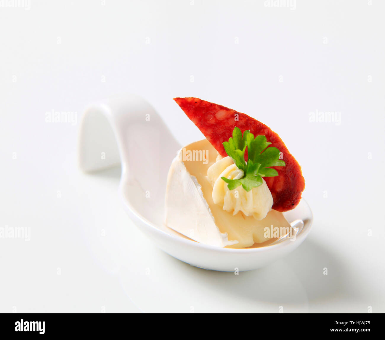 Bite-sized cheese appetizer on a porcelain spoon Stock Photo - Alamy