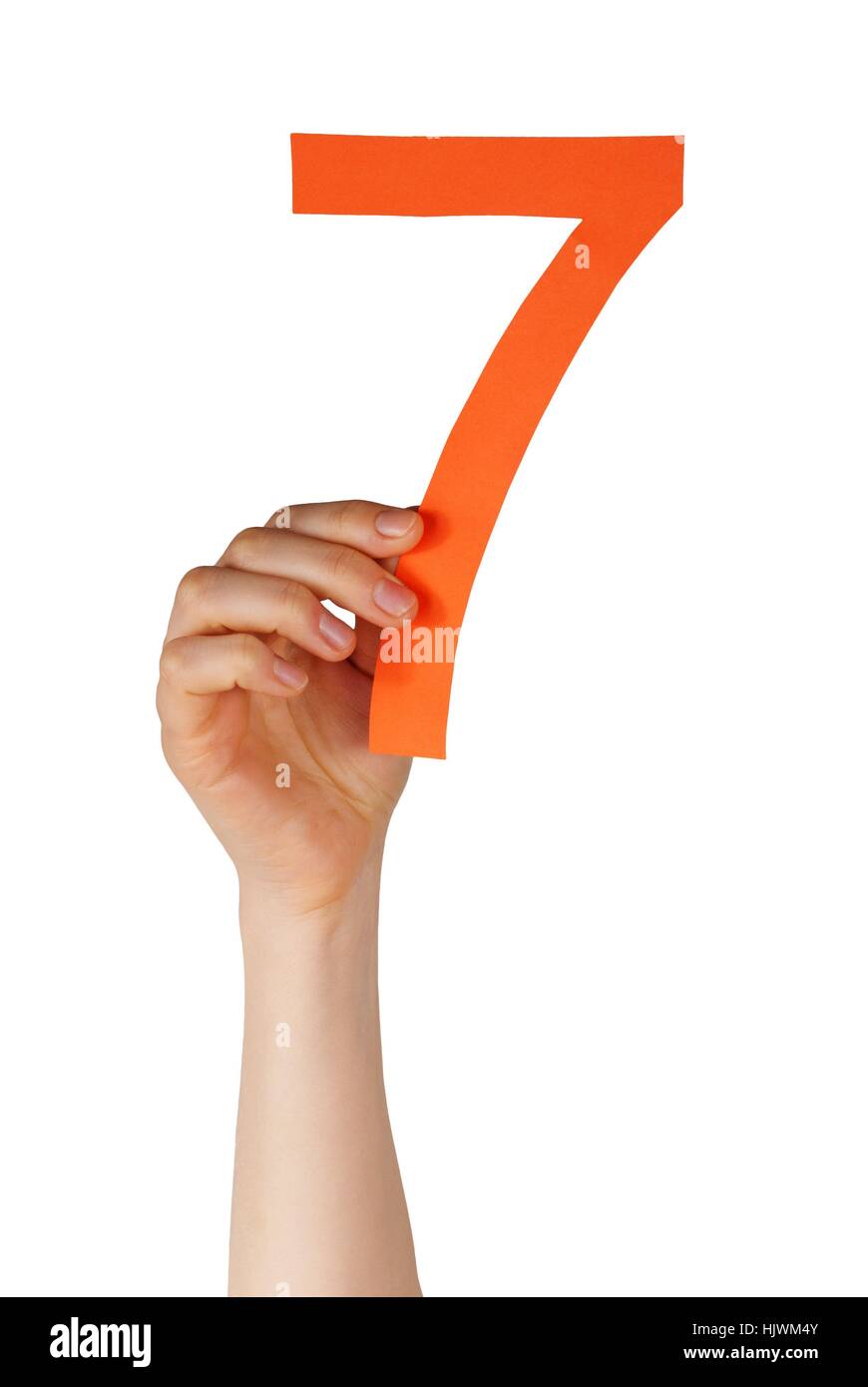 hand holding up an orange number seven, isolated Stock Photo - Alamy