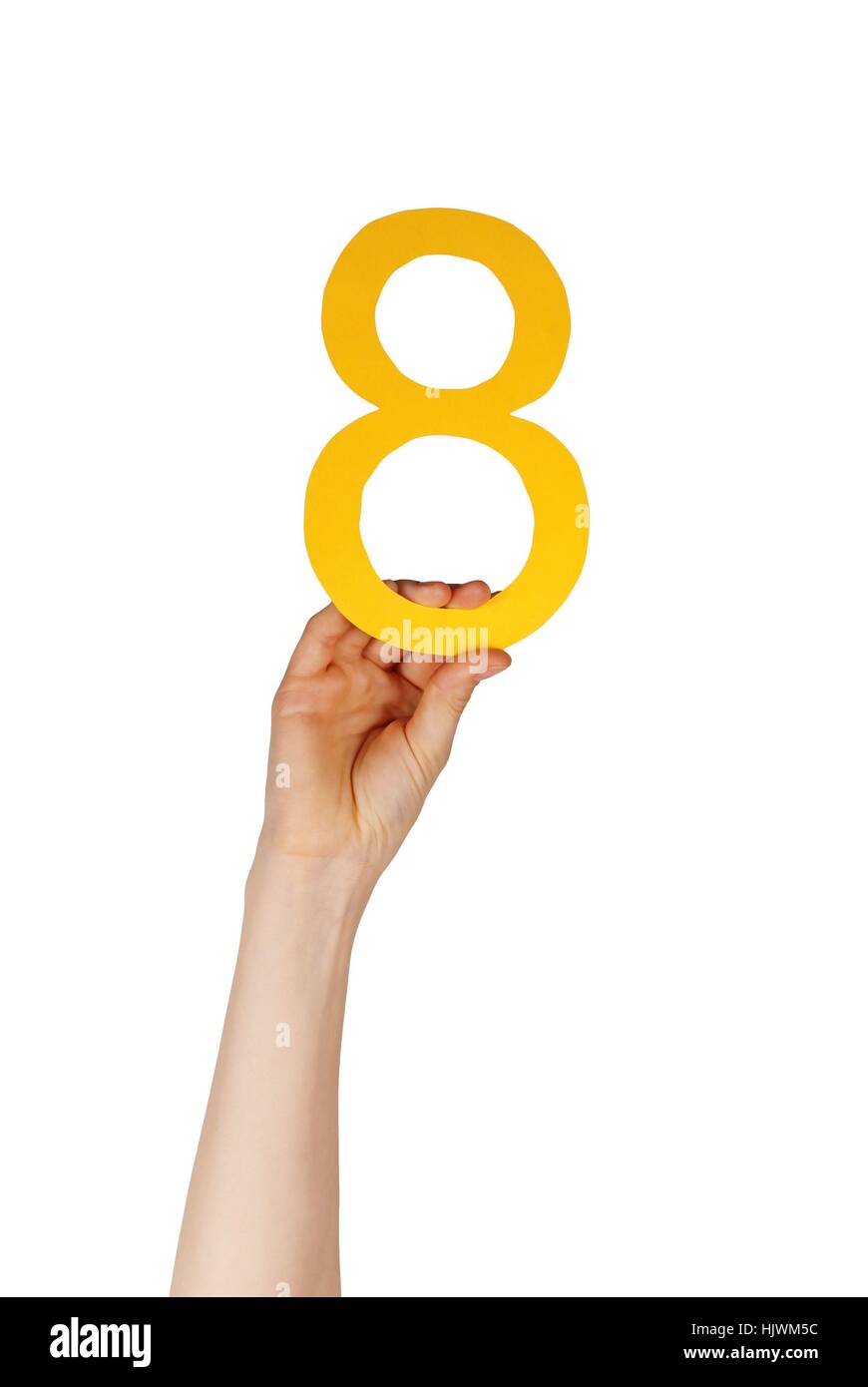 a hand holding up a yellow number eight, isolated Stock Photo - Alamy