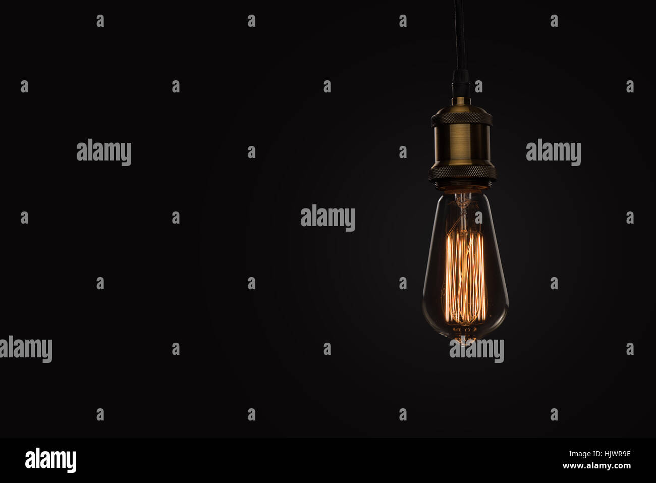 classic Edison light bulb on black background with space for text Stock ...