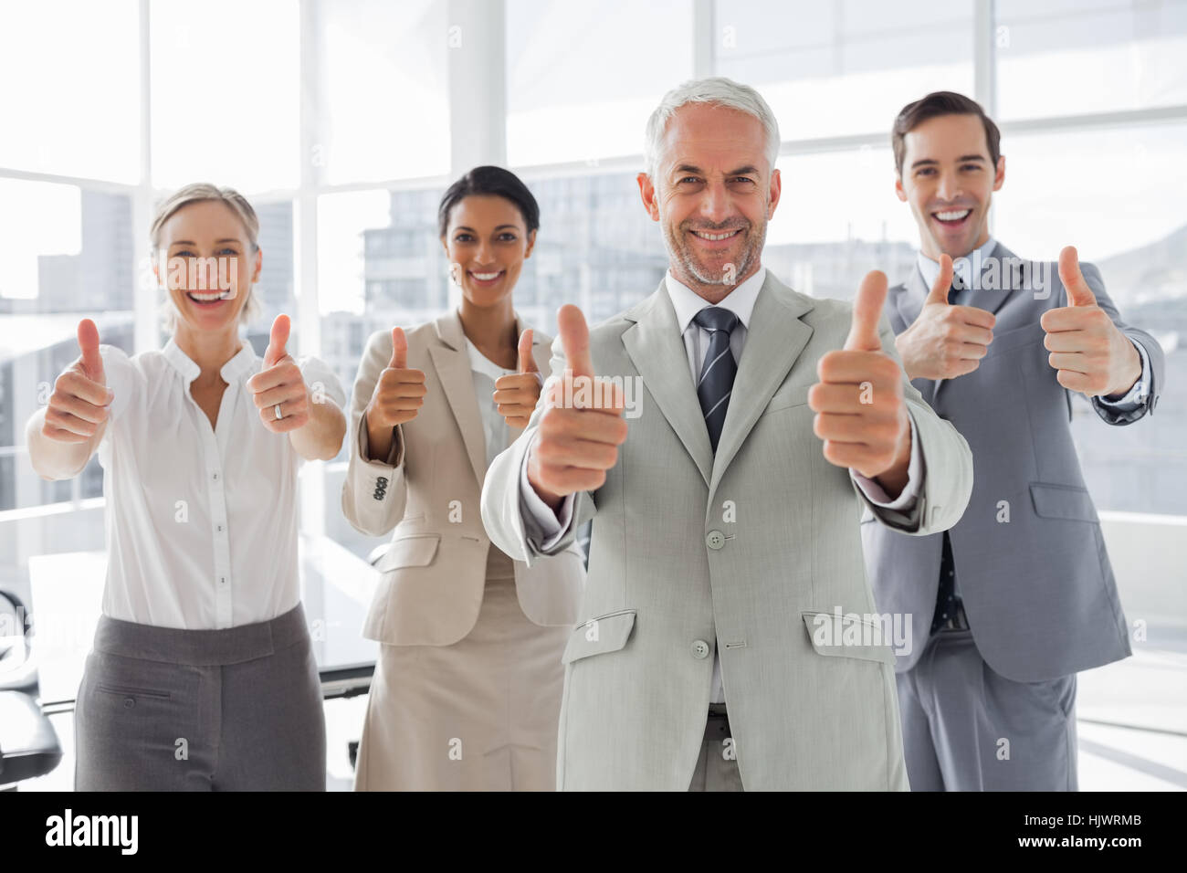 Business people giving thumbs up in the meeting room Stock Photo - Alamy