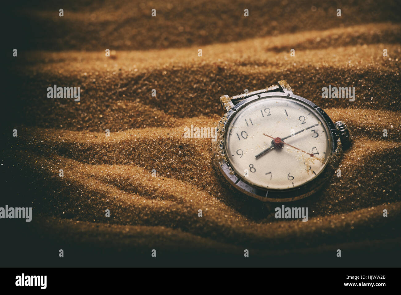 Old watch on sand hi-res stock photography and images - Alamy