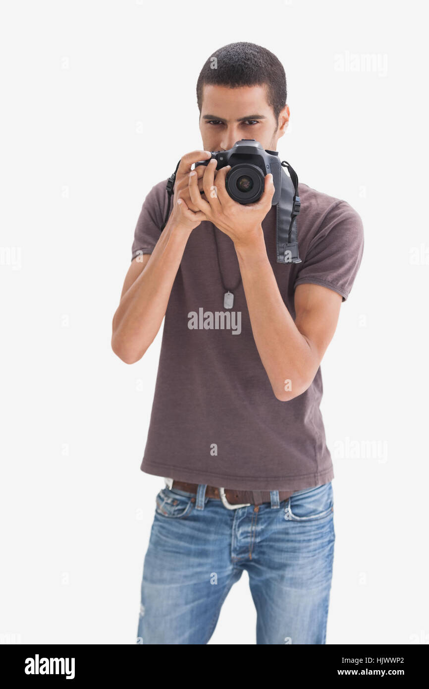 Young man pointing his camera at the camera on white background Stock ...